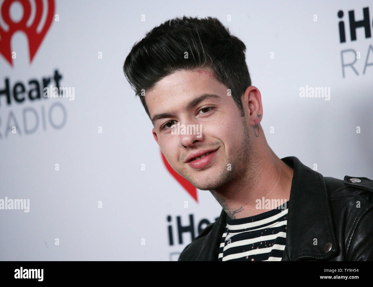Travis Mills arrives in the press room for the iHeartRadio Music ...