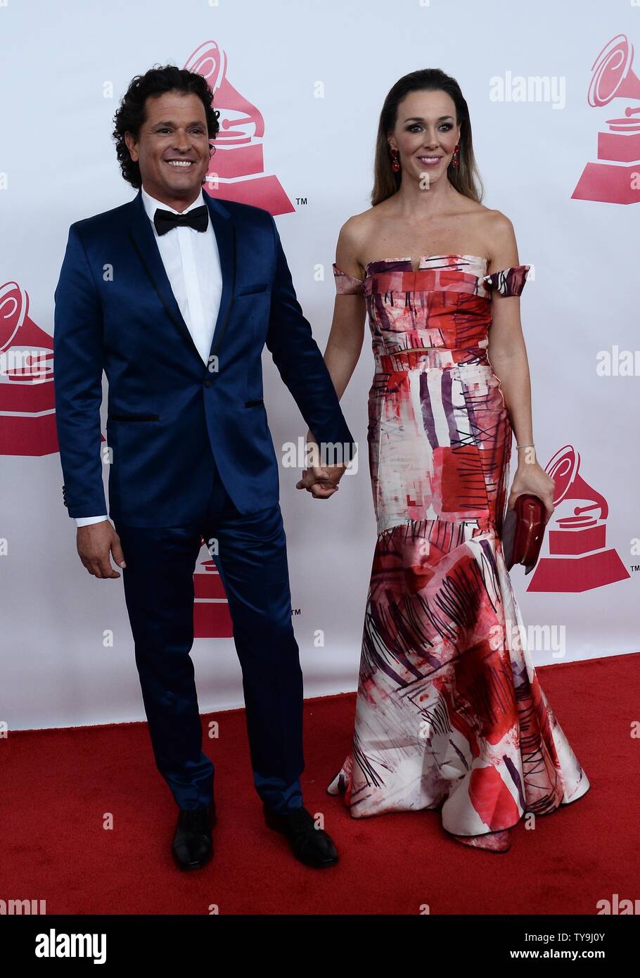Carlos Vives (L) and Claudia Elena arrive for the Latin Recording ...