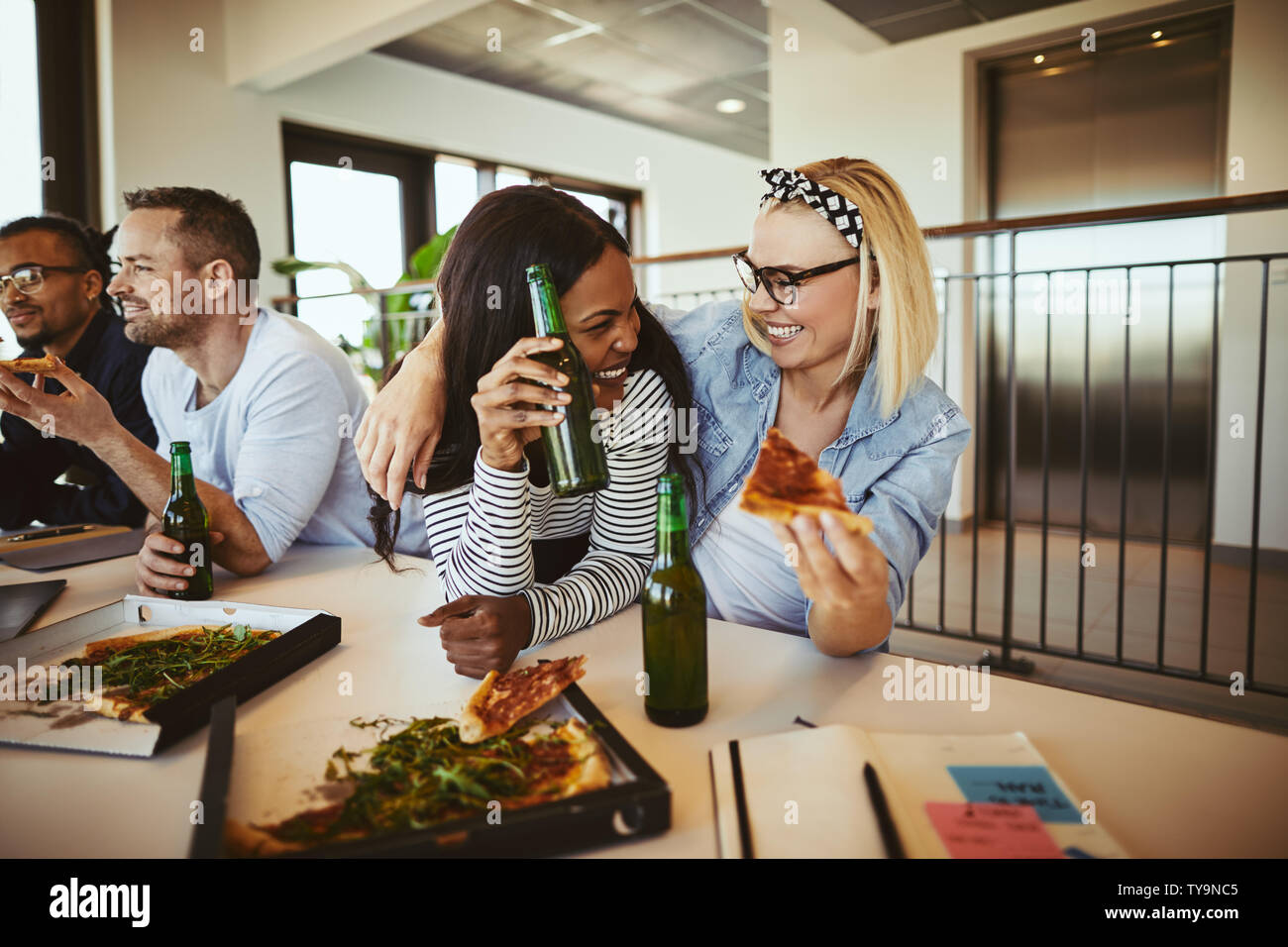 Two women at work laughing together hi-res stock photography and images ...