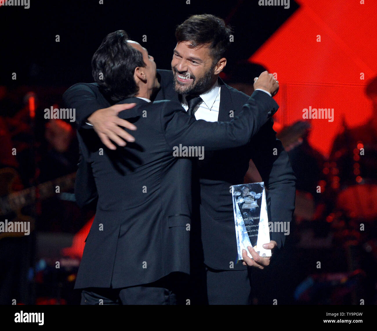 Recording artist Ricky Martin (R) presents honoree Marc Anthony with ...