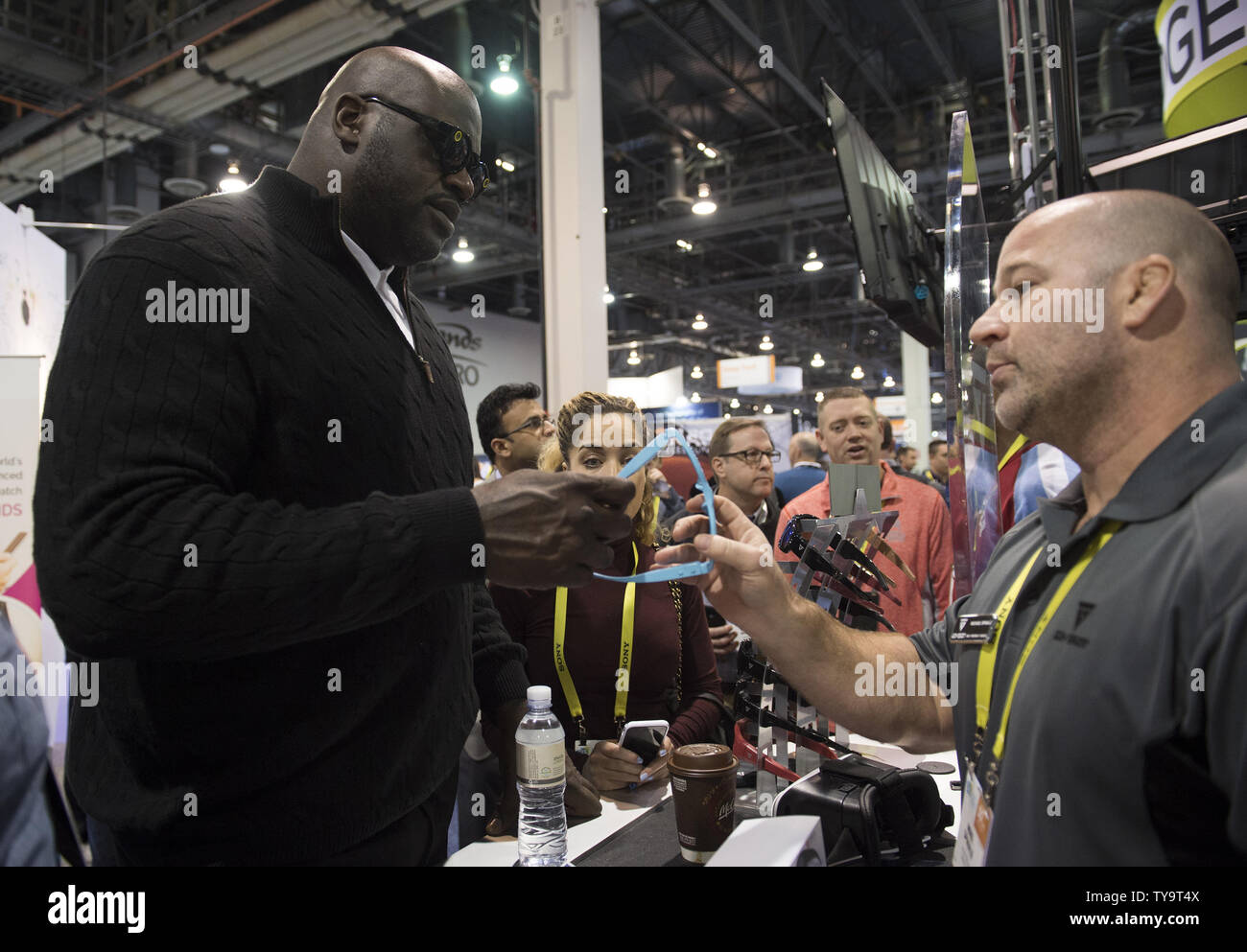 Shaquille O'Neal looks at a pair of GoVision SOL bluetooth sunglasses ...