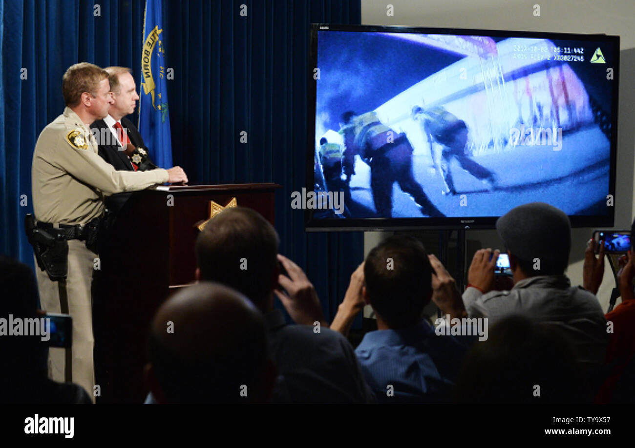 LVMPD Undersheriff Kevin McMahill (L) views body cam footage with ...