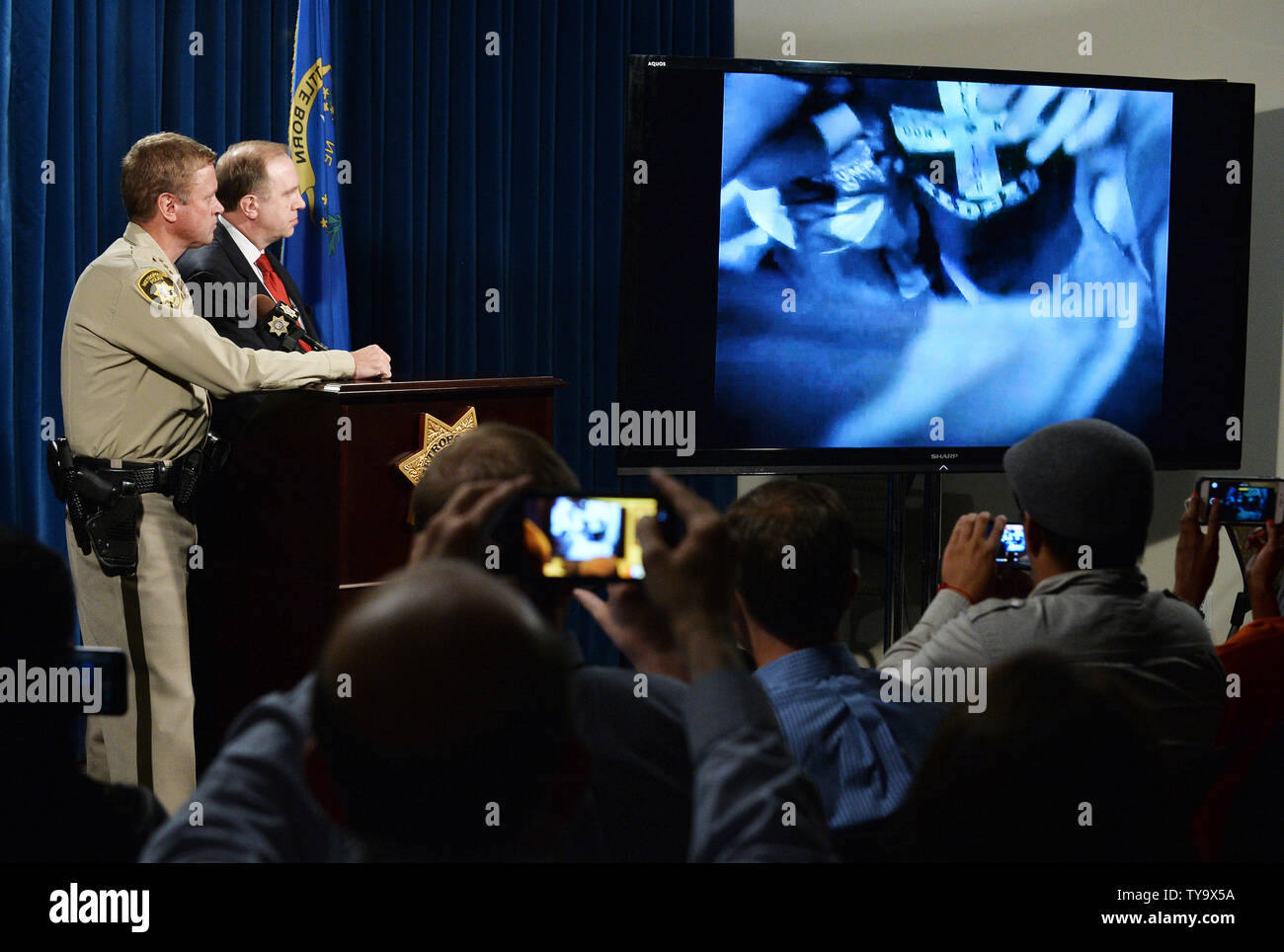 LVMPD Undersheriff Kevin McMahill (L) views body cam footage with ...