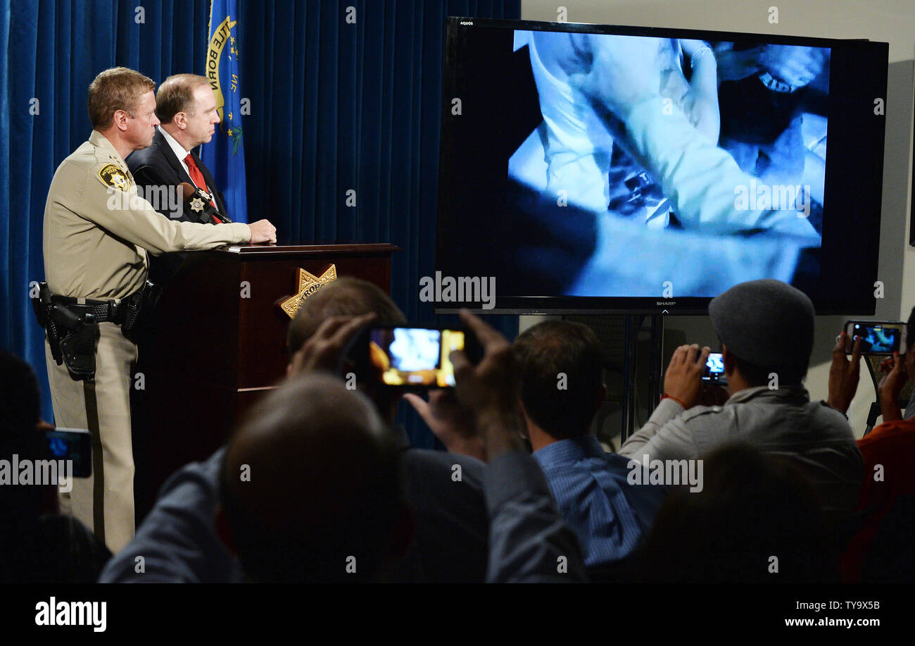 LVMPD Undersheriff Kevin McMahill (L) views body cam footage with ...