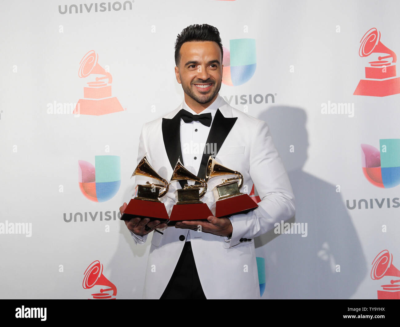 Luis Fonsi appears backstage with the awards for record of the year ...