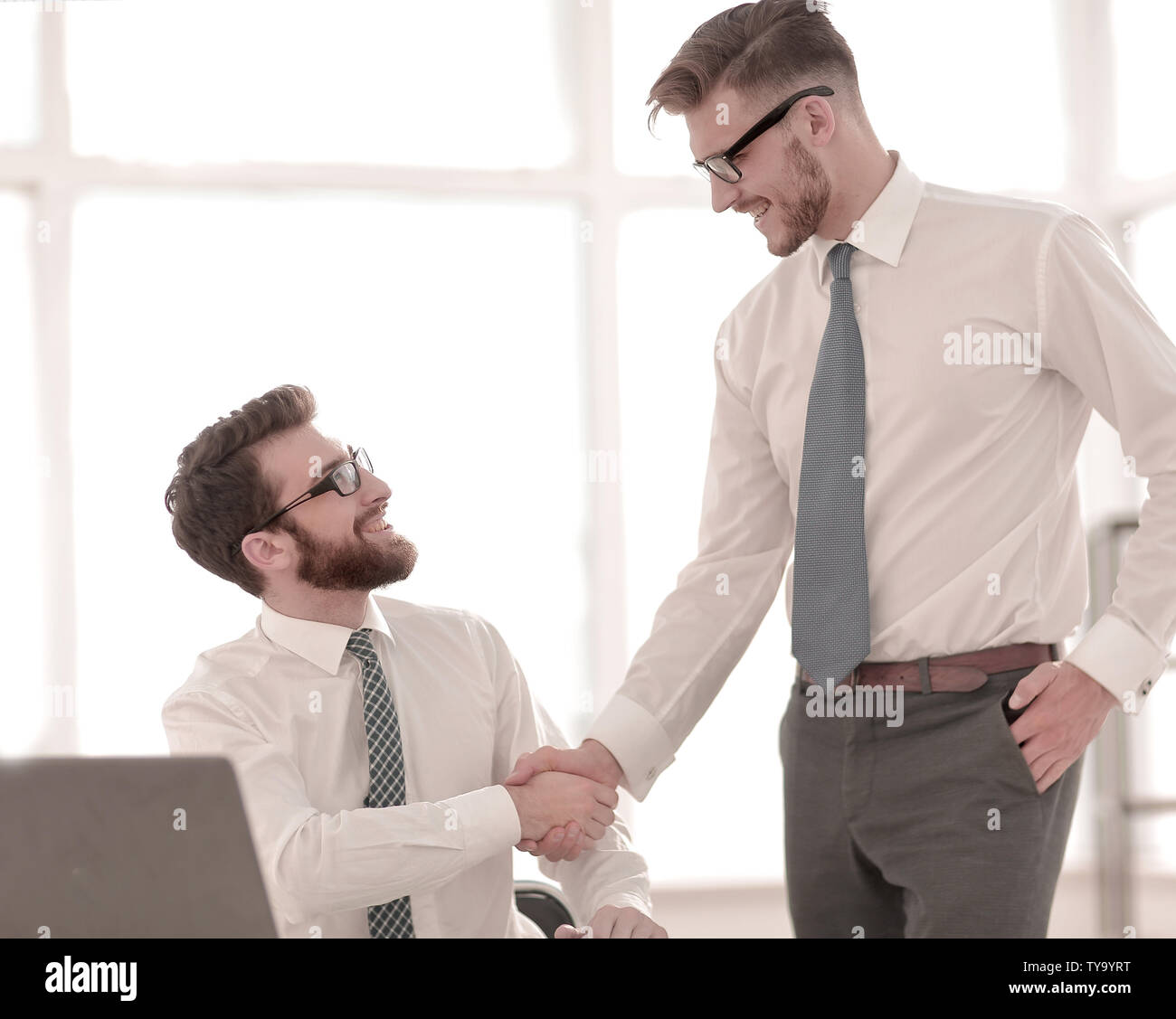 handshake employees in the workplace in the office Stock Photo - Alamy