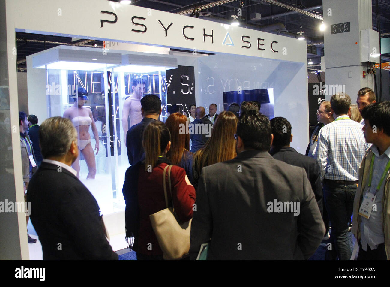 A crowd gathers around the PSYCH-SEC booth displaying whole-body ...