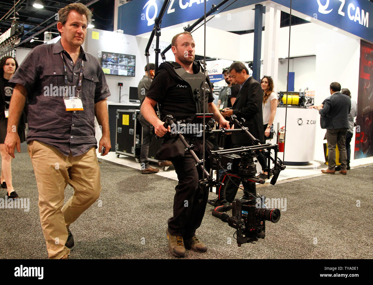 A camera operator wearing a camera stablizer system for filming at low ...