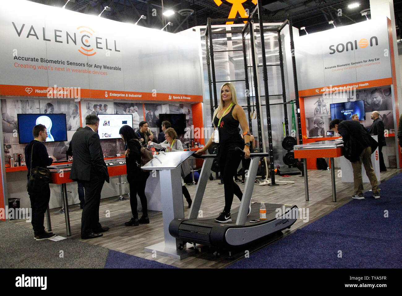 A view of a model exercising on a tread mill while wearing an arm band ...