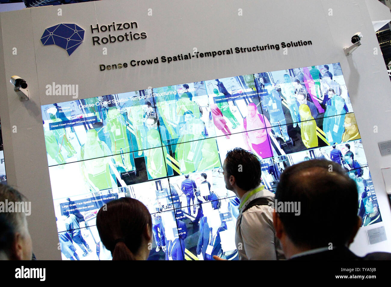 Attendees watch a wall size screen demonstration of Horizon Robotics ...