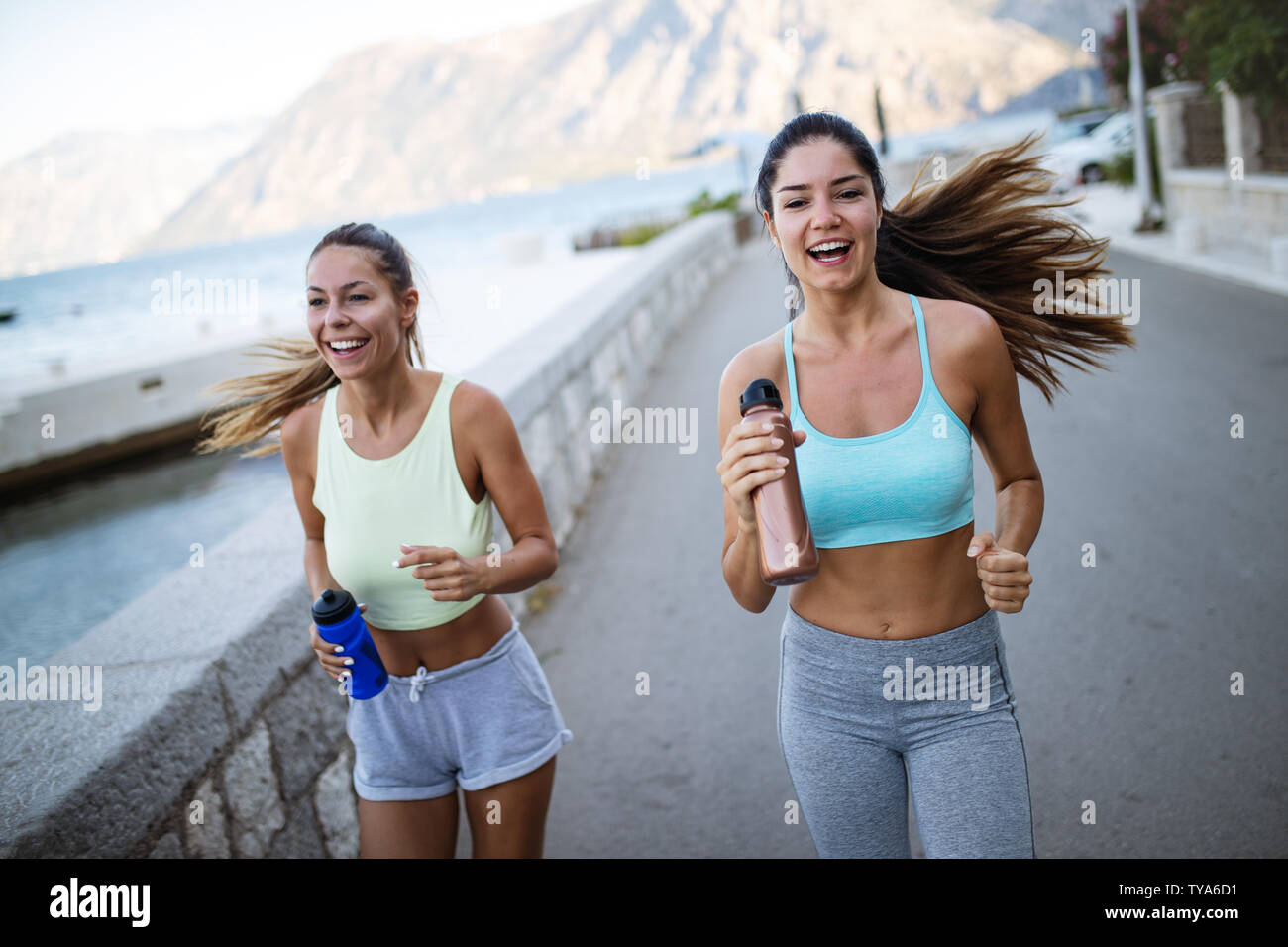 Outdoor portrait of group of friends running and jogging in nature ...