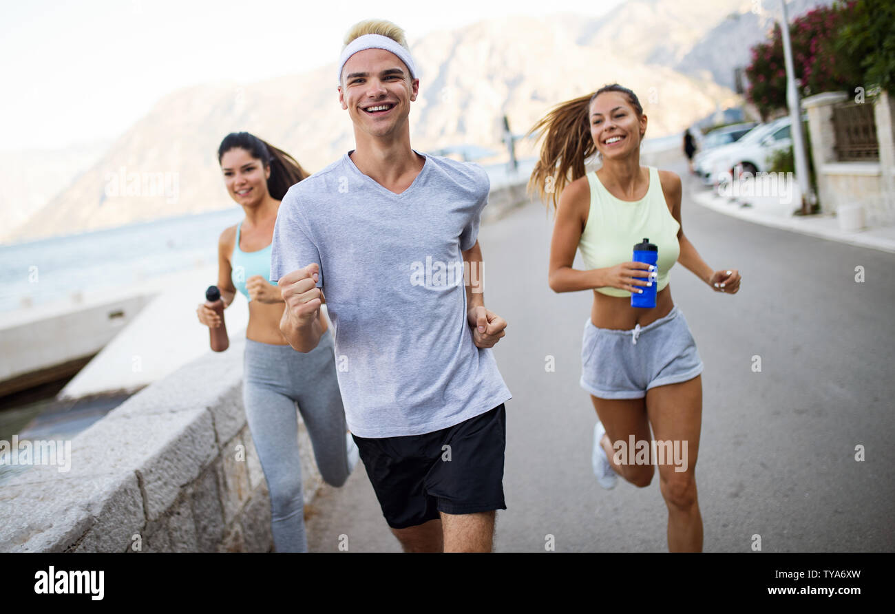 Group of young people friends running outdoors at seaside Stock Photo ...