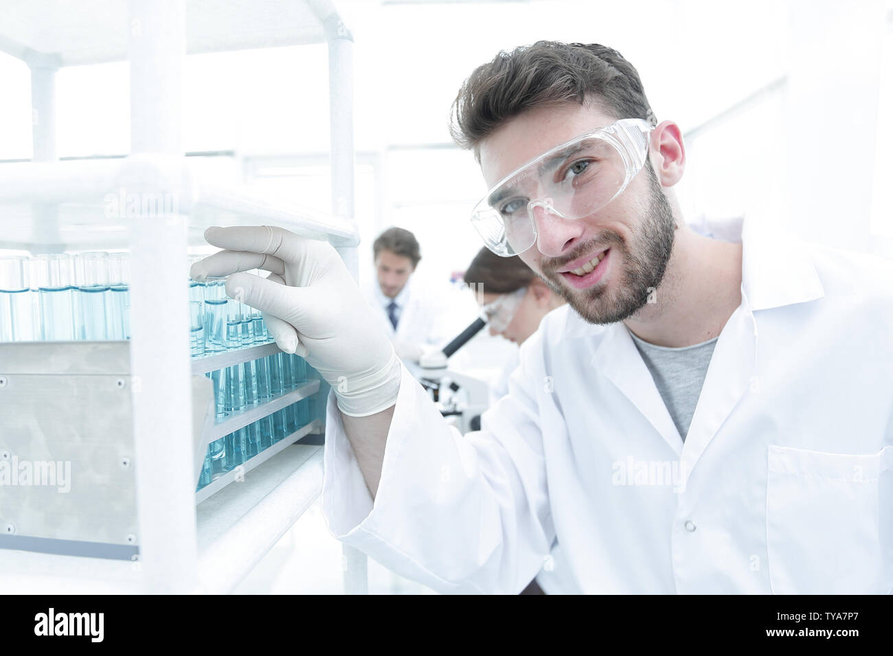 A young man doing an experiment in a chemical laboratory Stock Photo ...