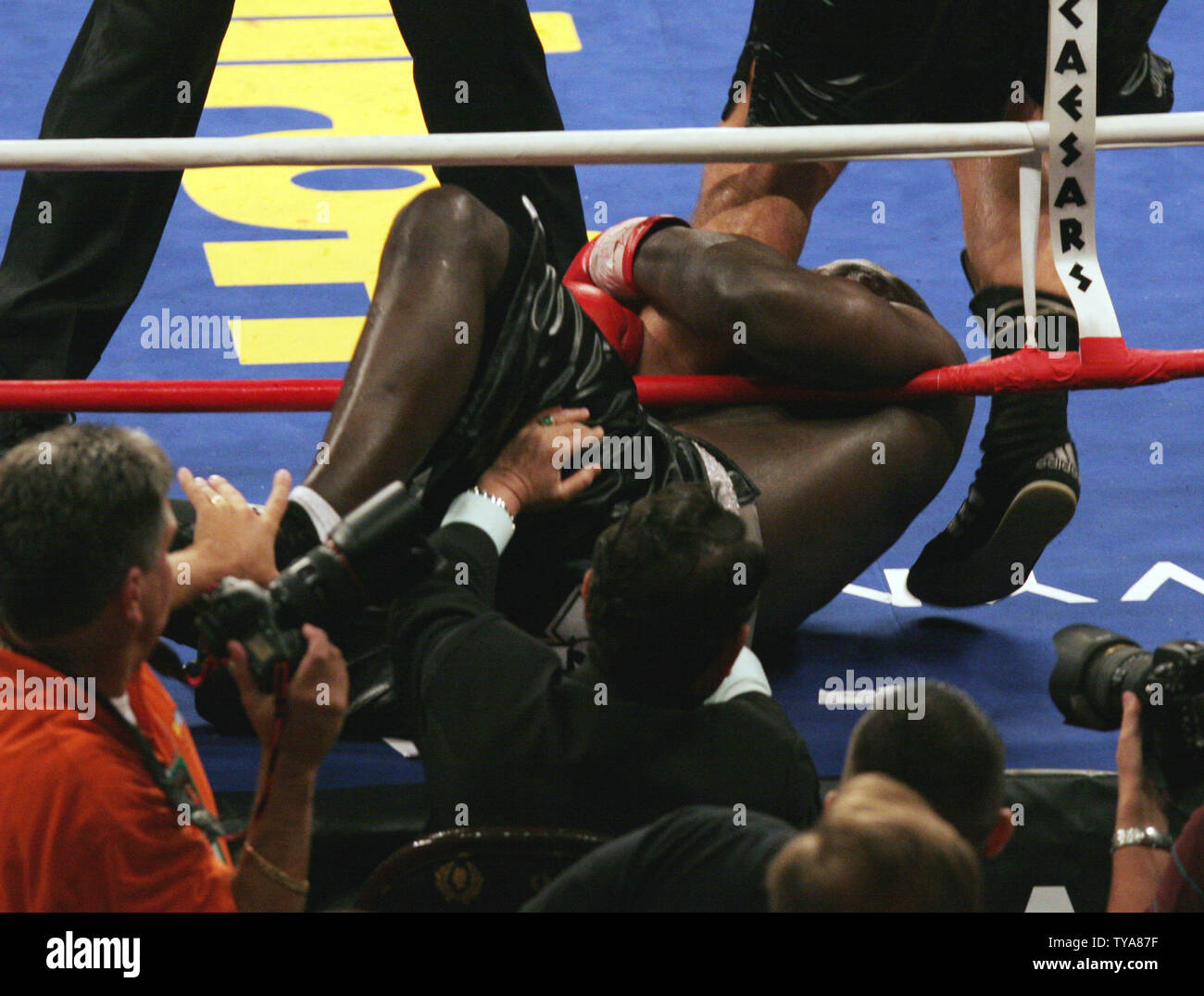 American Hasim Rahman hangs on the ropes after exchanging blows with ...