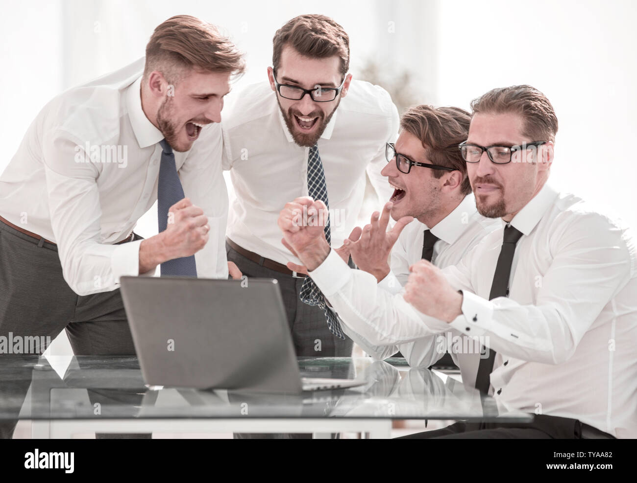 very happy business team standing near the desktop Stock Photo - Alamy