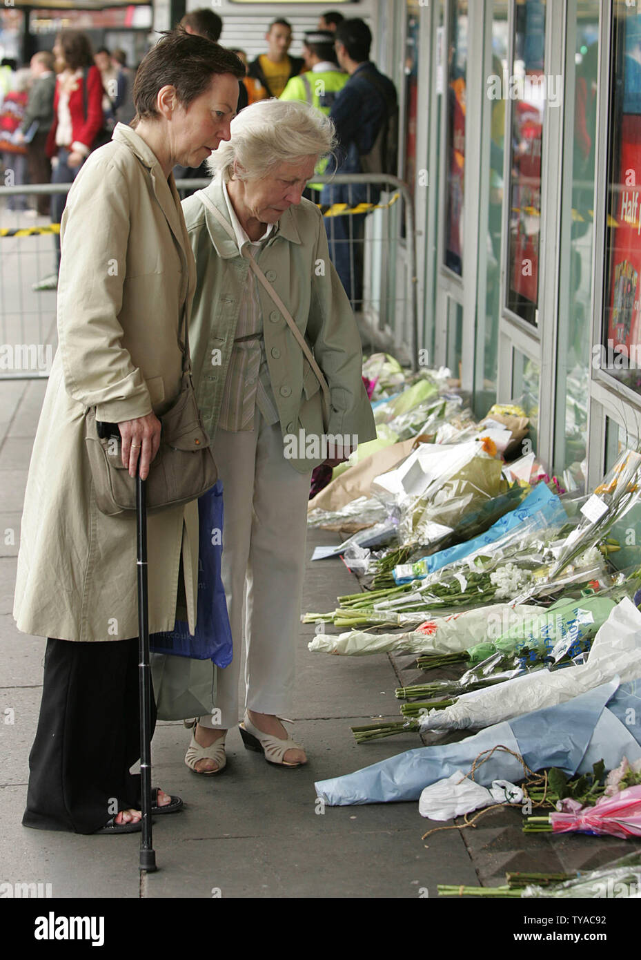 Two women pay tribute to the victims at King's Cross station where one ...
