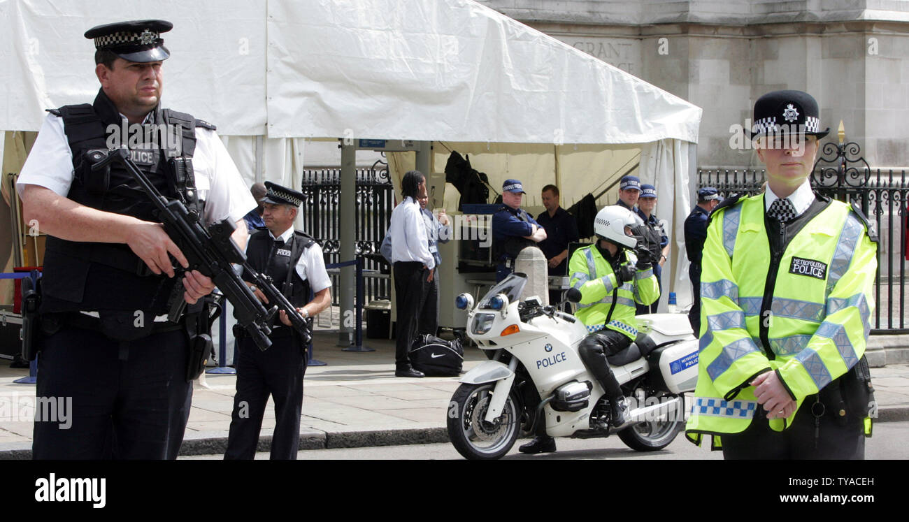 Armed metropolitan police officers keep watch during the memorial ...