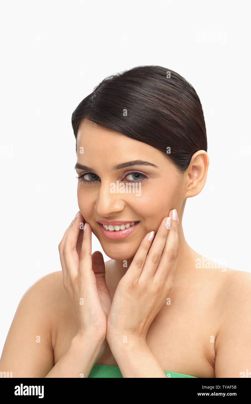 Portrait of a woman touching her cheeks and smiling Stock Photo - Alamy