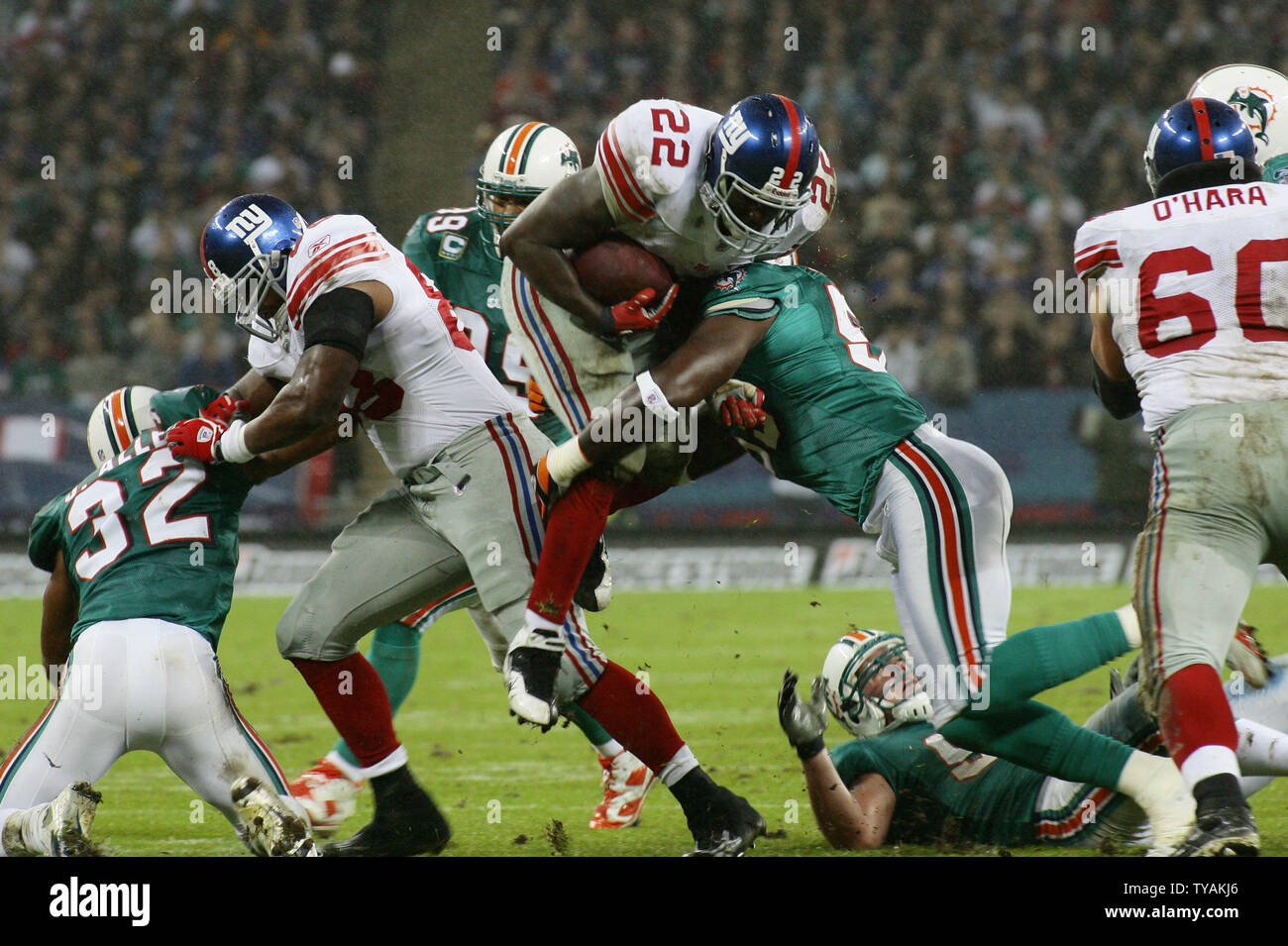 New York Giants Reuben Droughns is stopped by members of the Miami ...