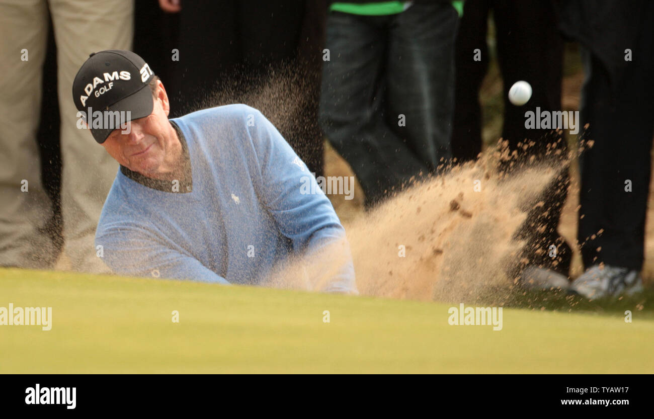 American Tom Watson hits out of the bunker on the 1st green on the ...