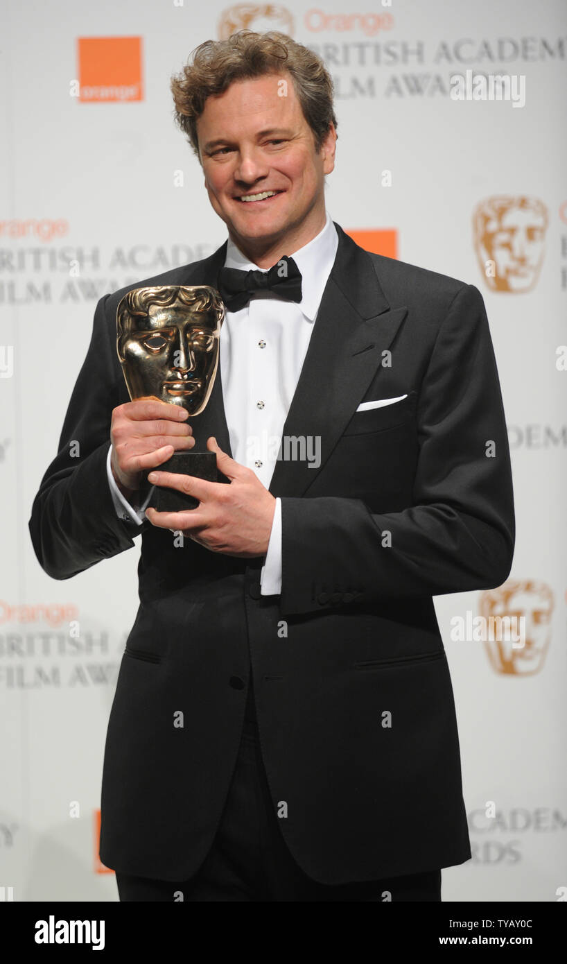 British actor Colin Firth holds his award for Best Actor in the press ...