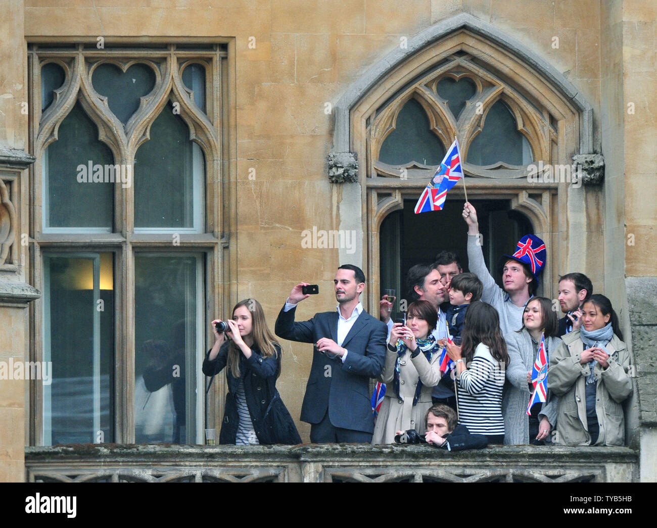 A crowd watches from a balcony as Kate Middleton arrives at Westminster ...