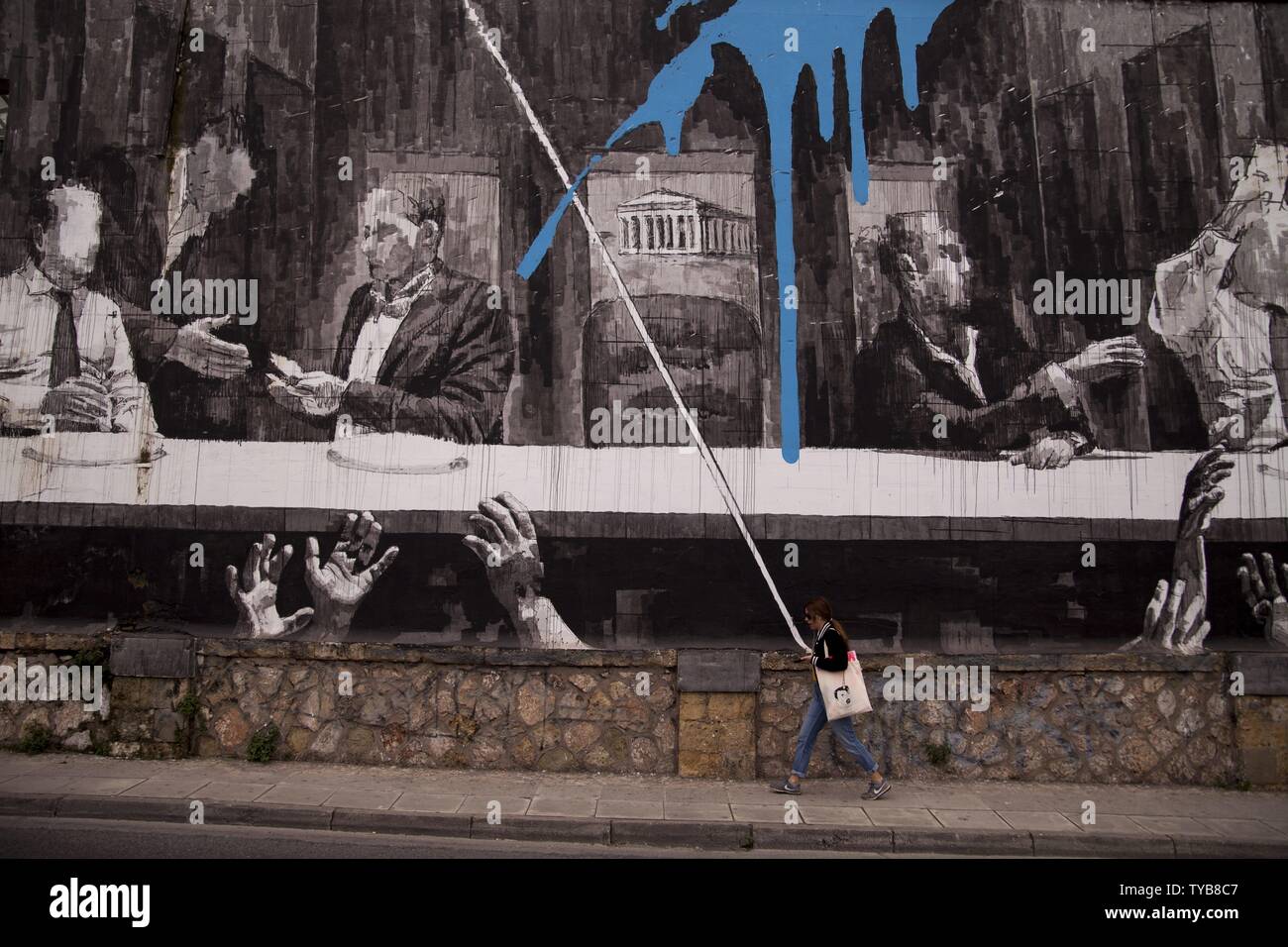 Greek woman in front of mural "The Supper with Greek politicians and ...