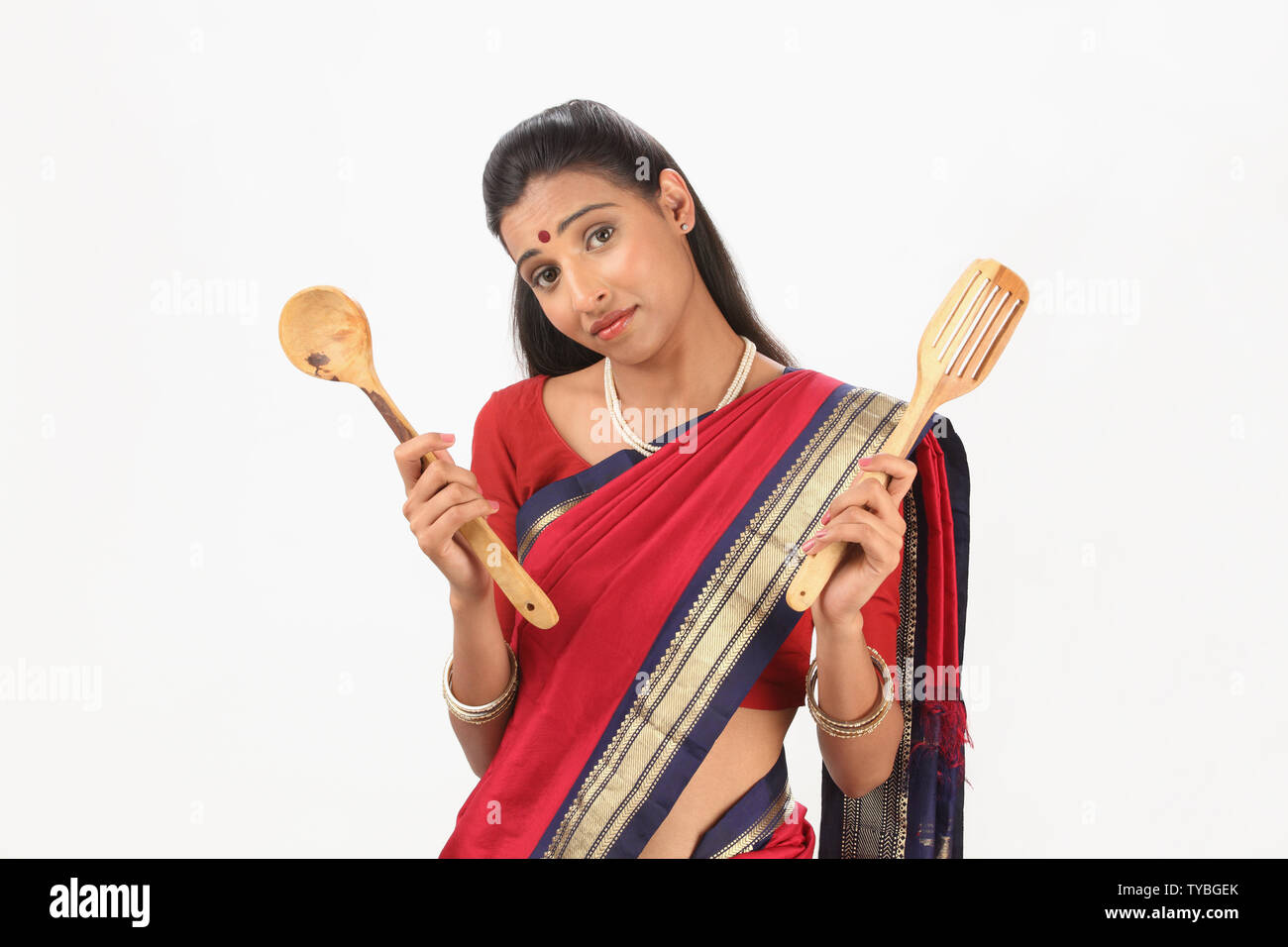 Woman holding kitchen utensils Stock Photo - Alamy