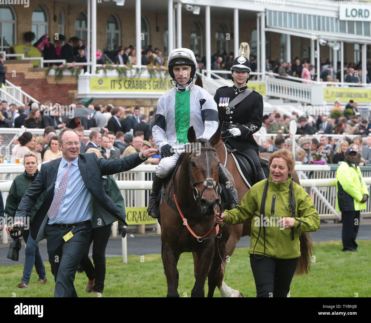 Jockey Leighton Aspell celebrates winning the 2014 Crabbies Grand ...