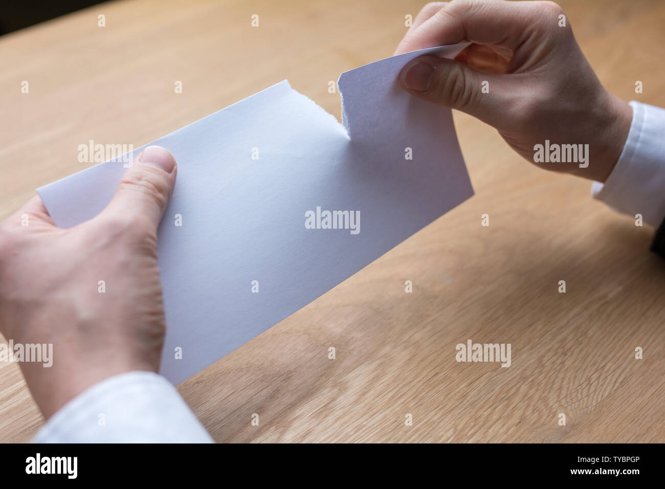 Tearing paper by scissors Stock Photo - Alamy