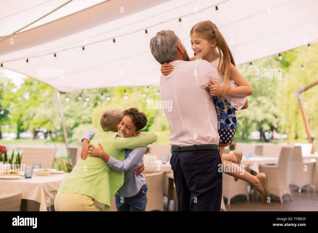 Loving granddaughter and grandson hugging grandparents Stock Photo - Alamy