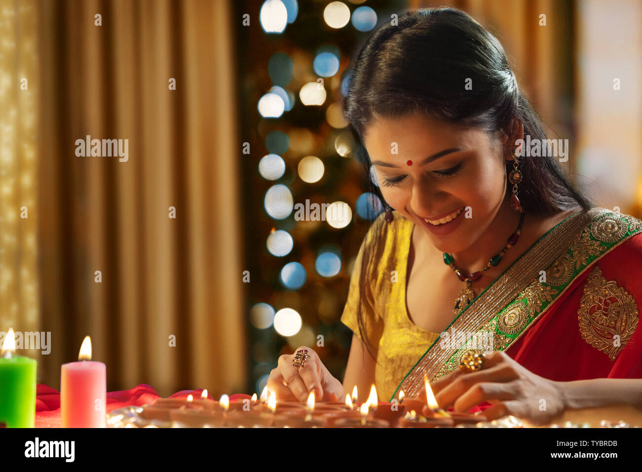 Woman decorating the house with diya on the occasion of diwali Stock ...