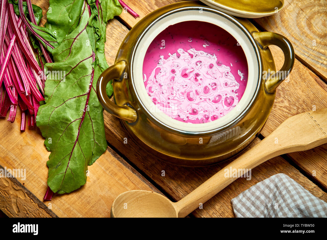 Old vase with cold beetroot soup and spoon on rustic wooden table Stock ...