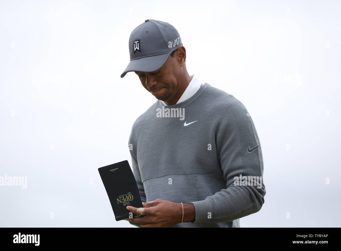 American Tiger Woods checks his course guide on the 13th tee on the ...
