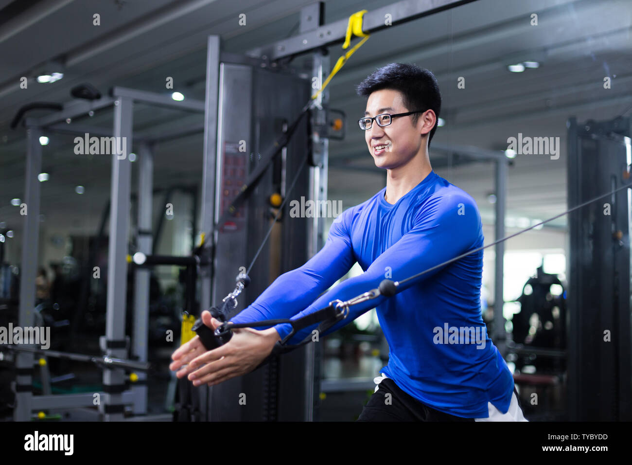 young asian man working out in modern gym Stock Photo - Alamy