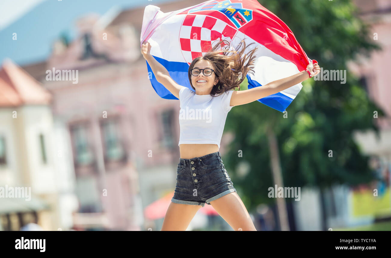 Happy girl tourist walking in the street with croatian flag Stock Photo ...