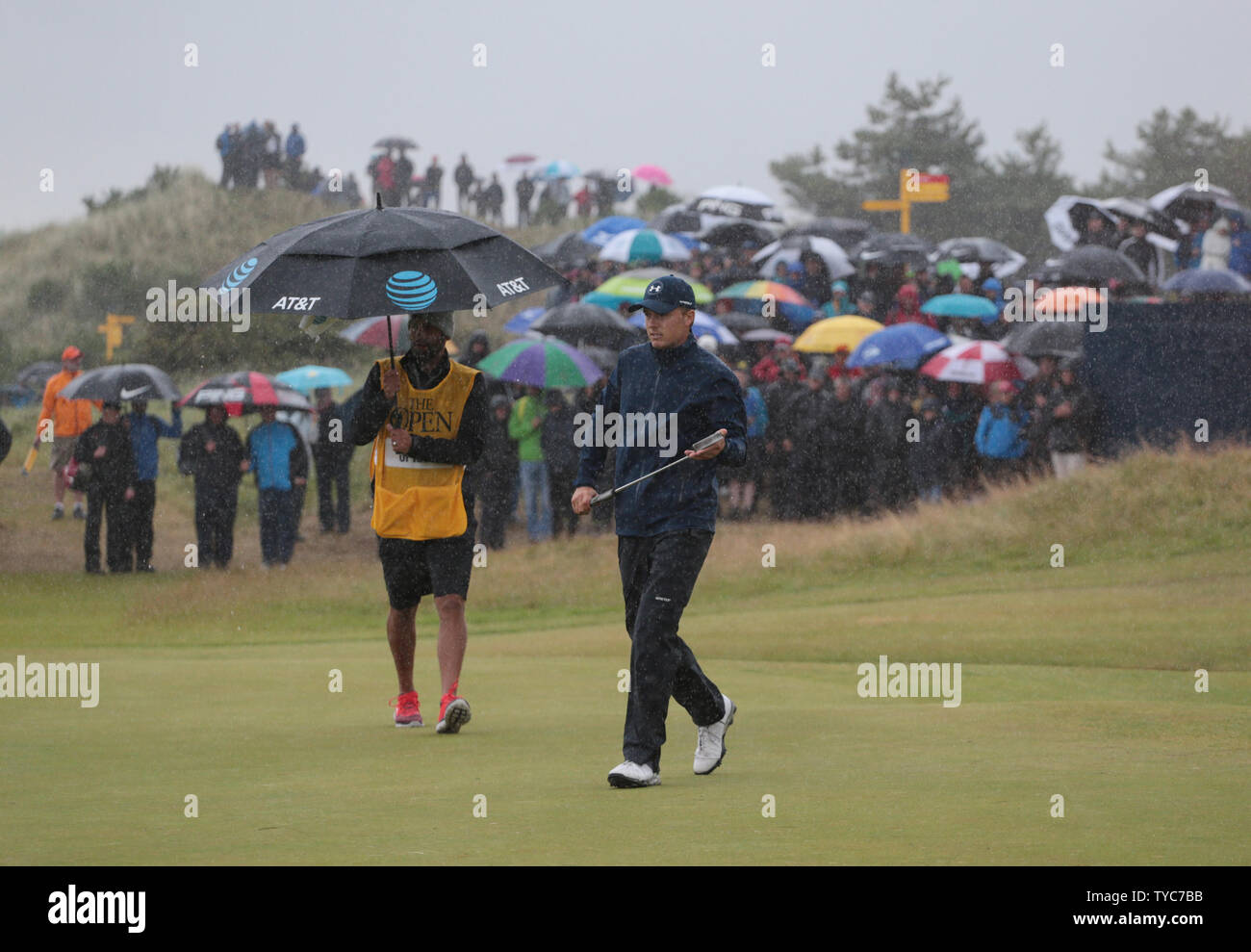 American Jordan Spieth walks on the 9th green in the rain on Day two at ...
