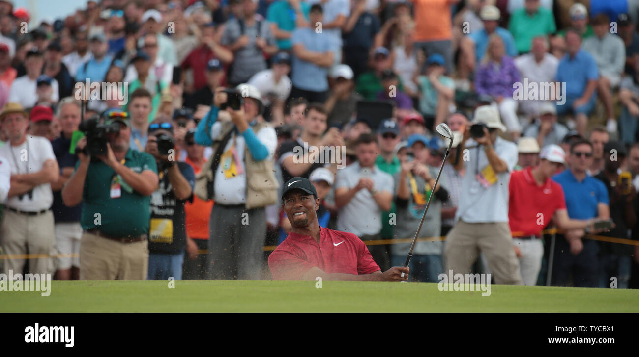 America's Tiger Woods hits out of a bunker in the final round of the ...