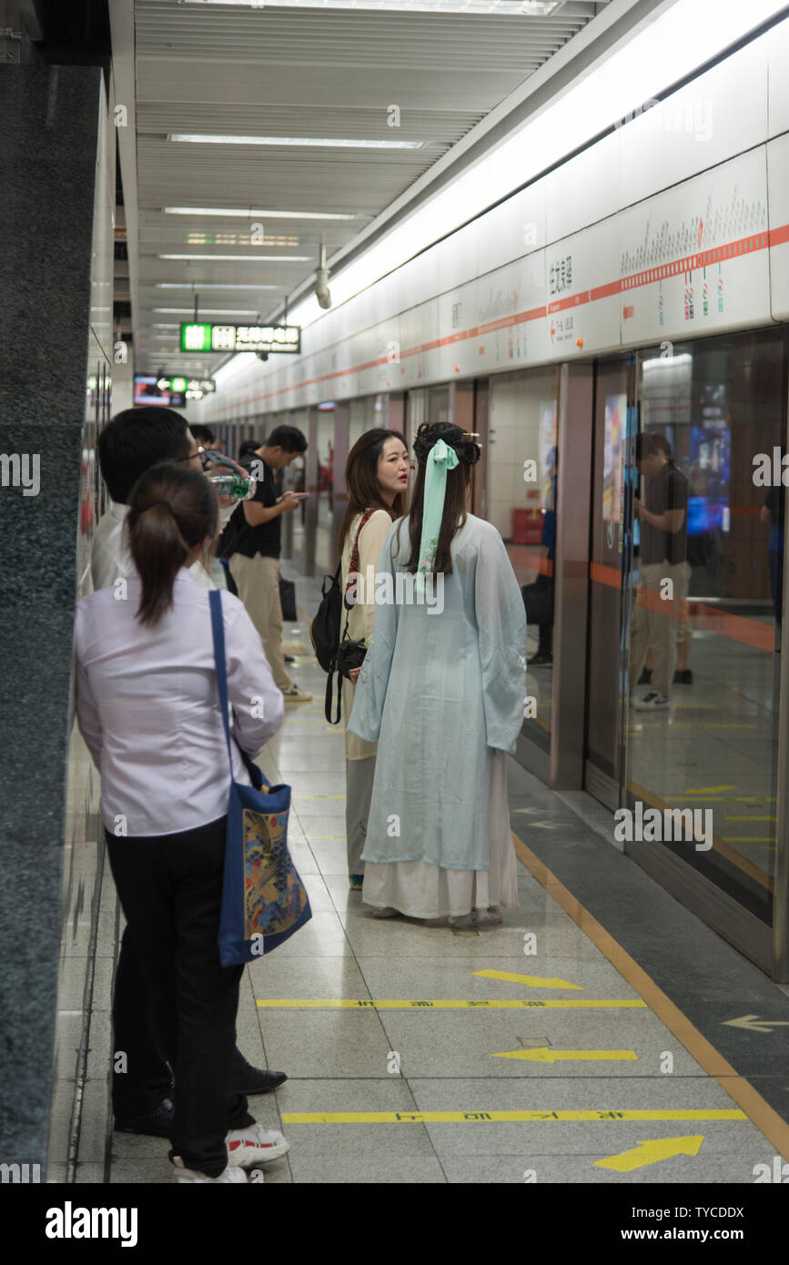 Chinese women in traditional Chinese clothes boarding a subway train ...