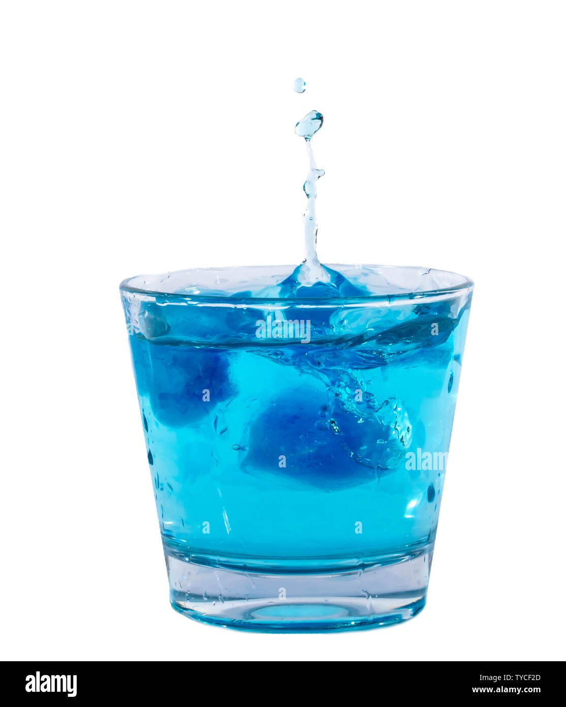 Blue ice cubes splashing into glass of water Stock Photo - Alamy