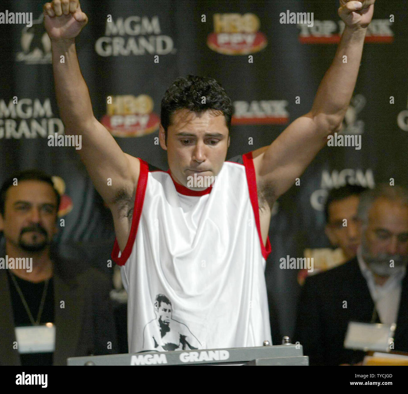 Oscar De La Hoya raises his arms after weighing in at 160 lbs for his ...