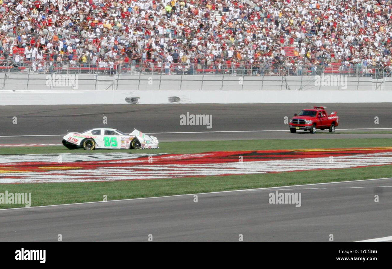 Race car driver Brett Rowe waits for the rescue truck in turn 4 after ...