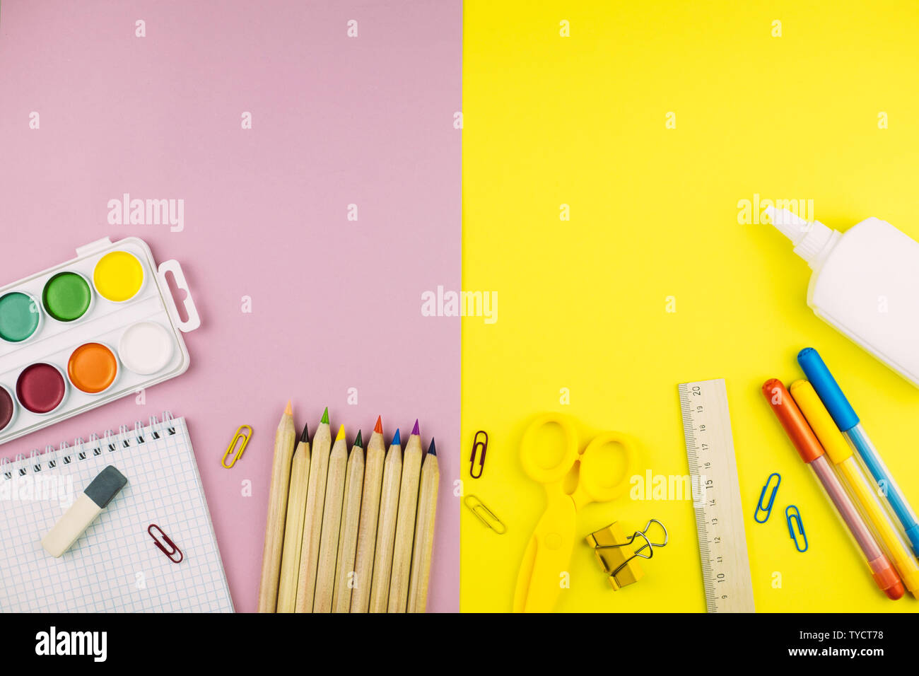 Different school supplies on pink and yellow paper background Stock ...