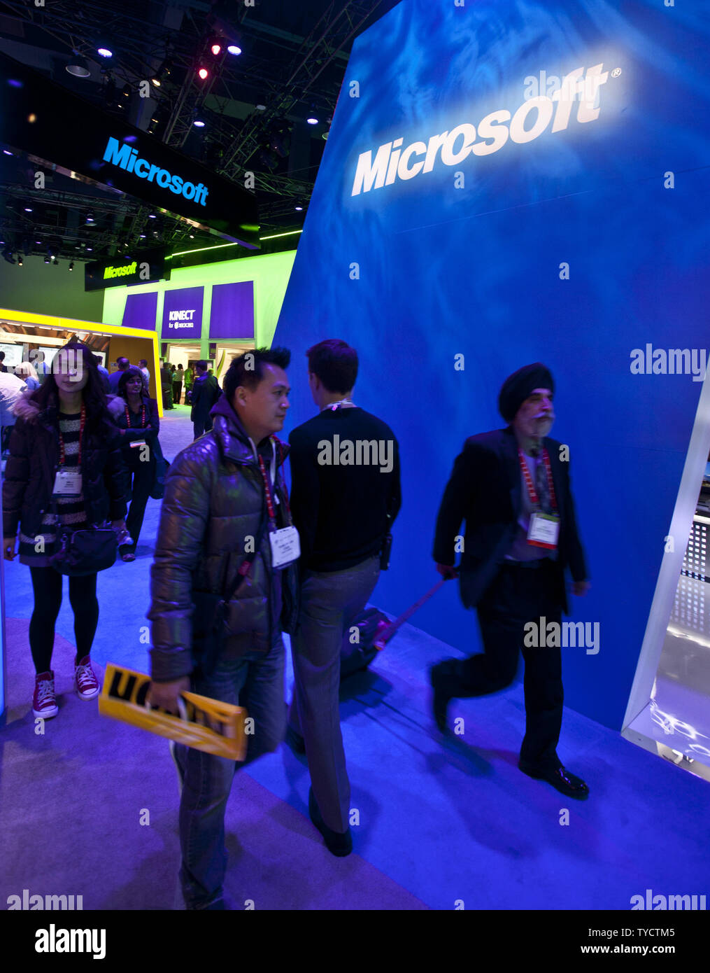 Attendees walk through the Microsoft exhibit at 2012 International CES ...