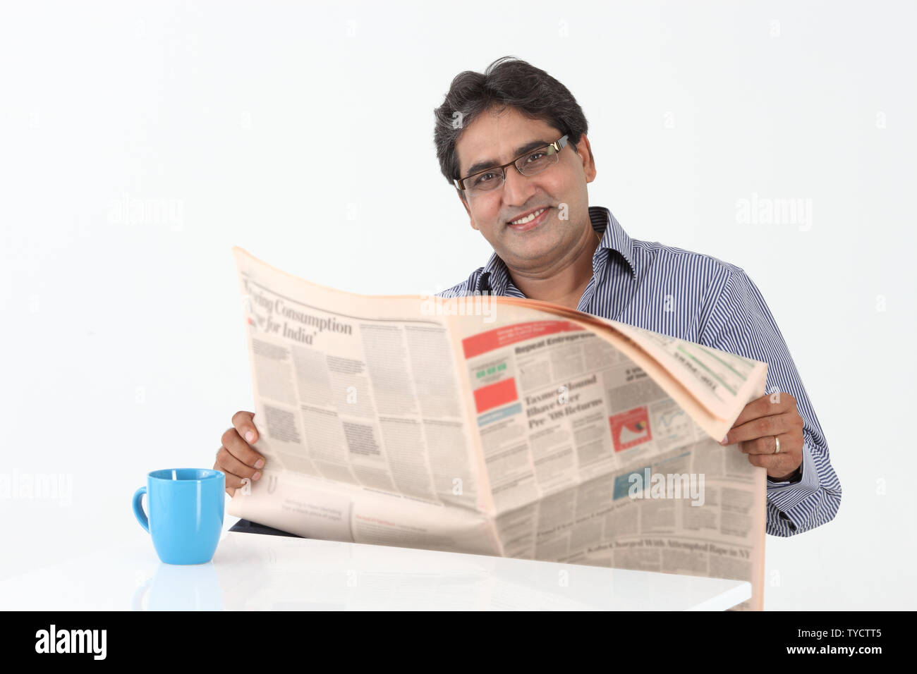 Man reading a newspaper and smiling Stock Photo - Alamy