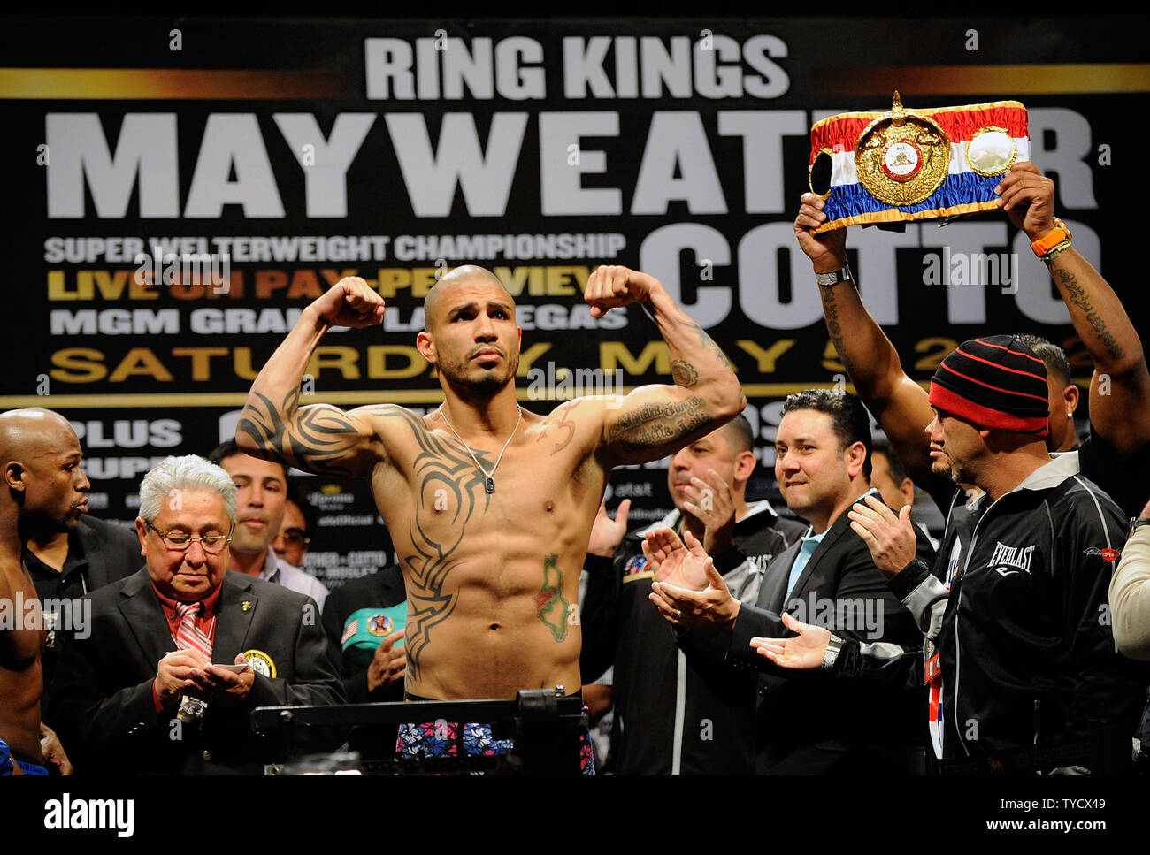 Puerto Rico boxer Miguel Cotto gestures on the scales during the weigh ...