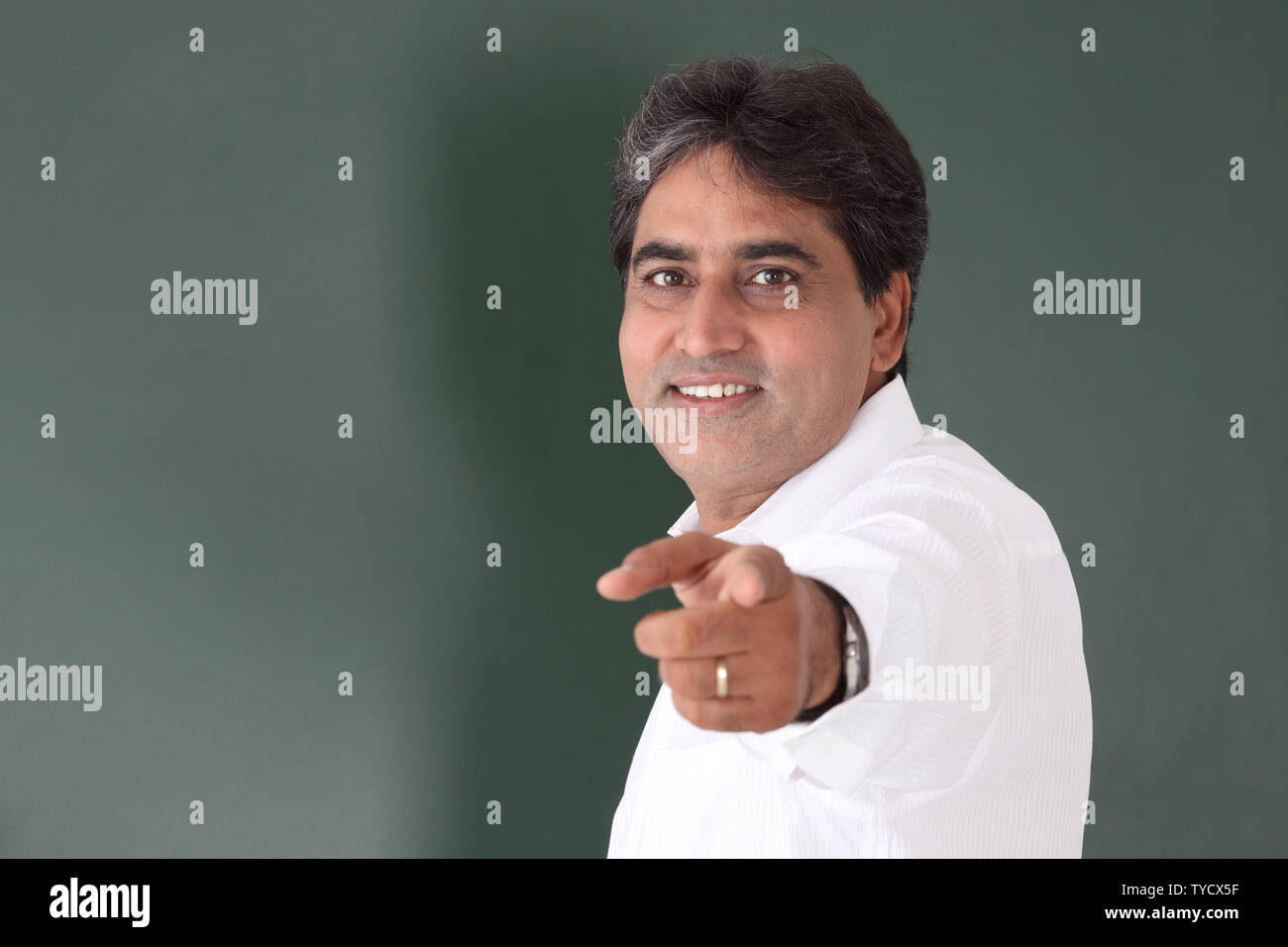 Teacher pointing in a classroom Stock Photo - Alamy