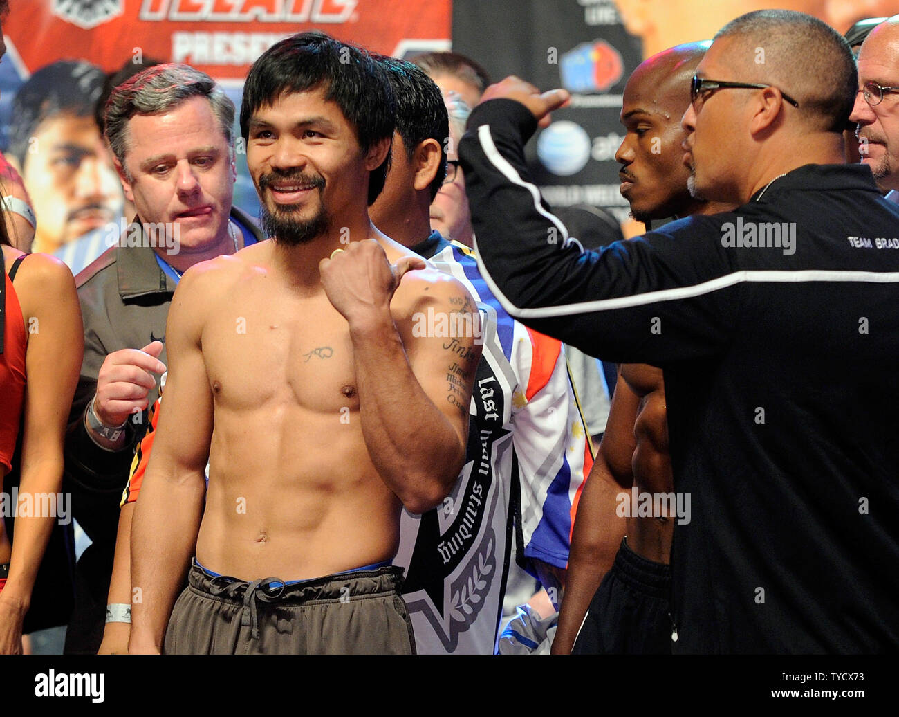 Boxers Manny Pacquiao, left, smiles as Timothy Bradley approaches for a ...