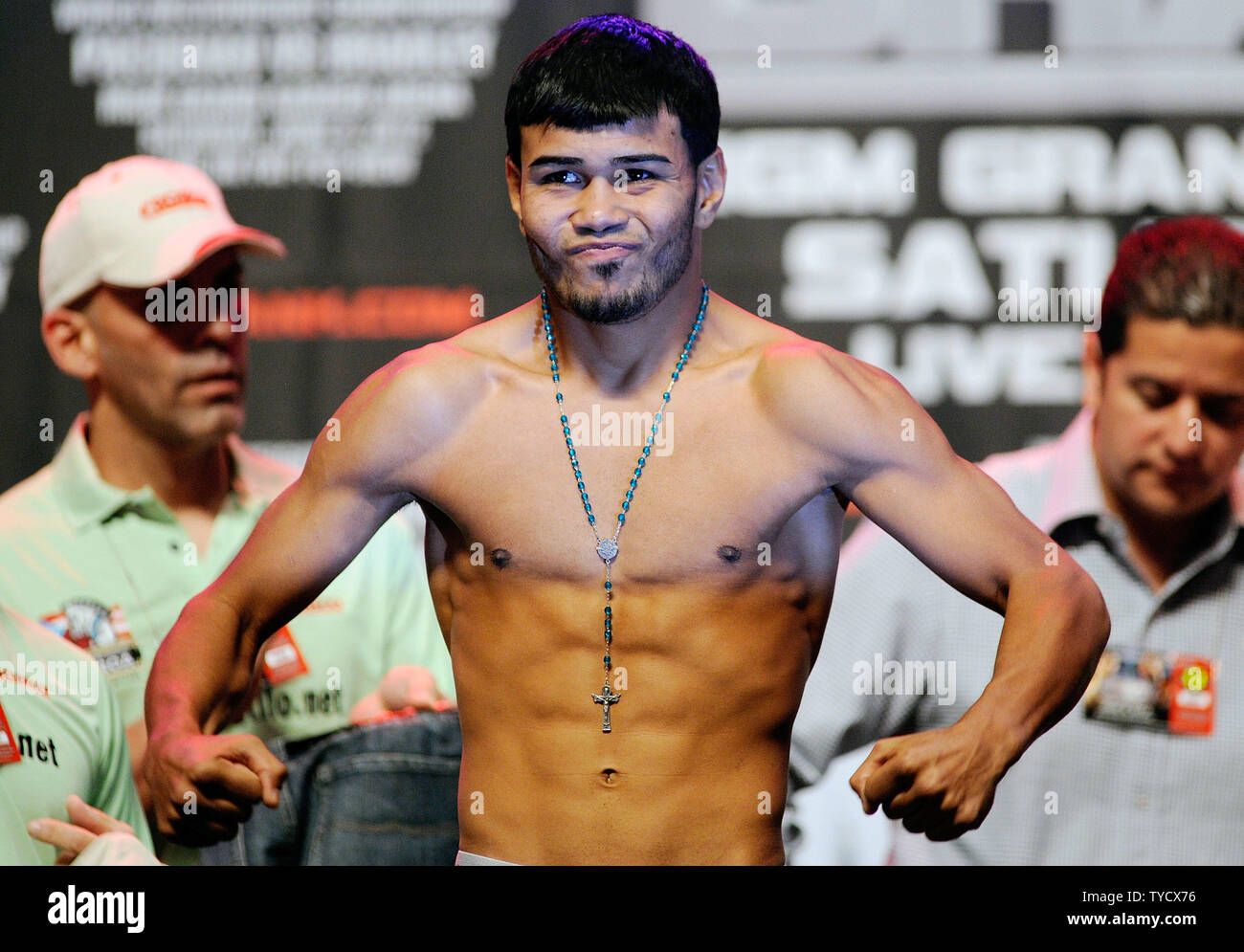 Boxer Jesus Rojas of Puerto Rico, poses on the scale during the ...
