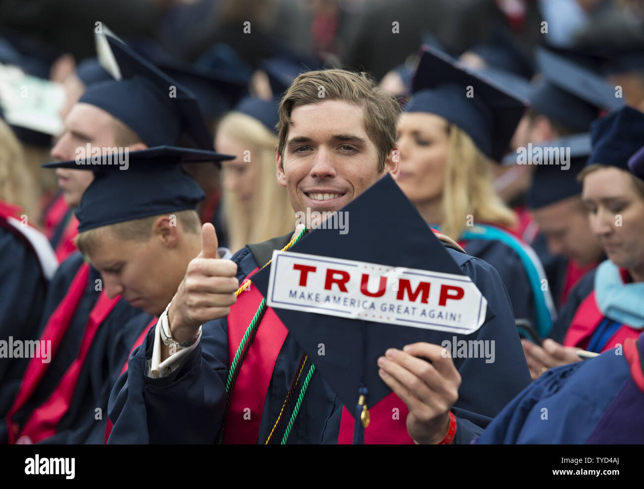 Graduate David Wescott shows off his Trump cap as he arrives for the ...